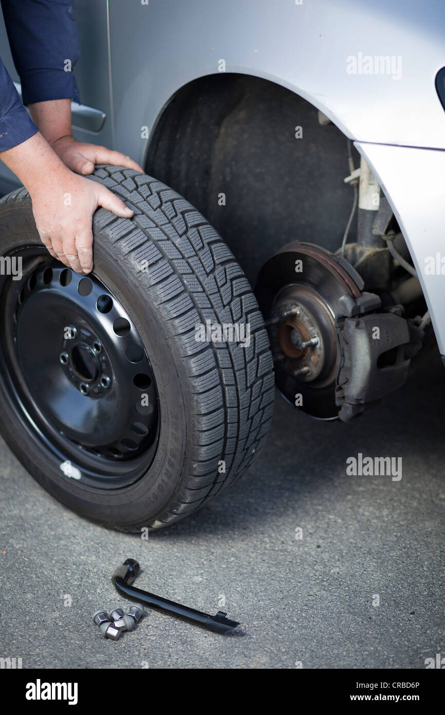 mechanic changing a wheel of a modern car (color toned image Stock ...