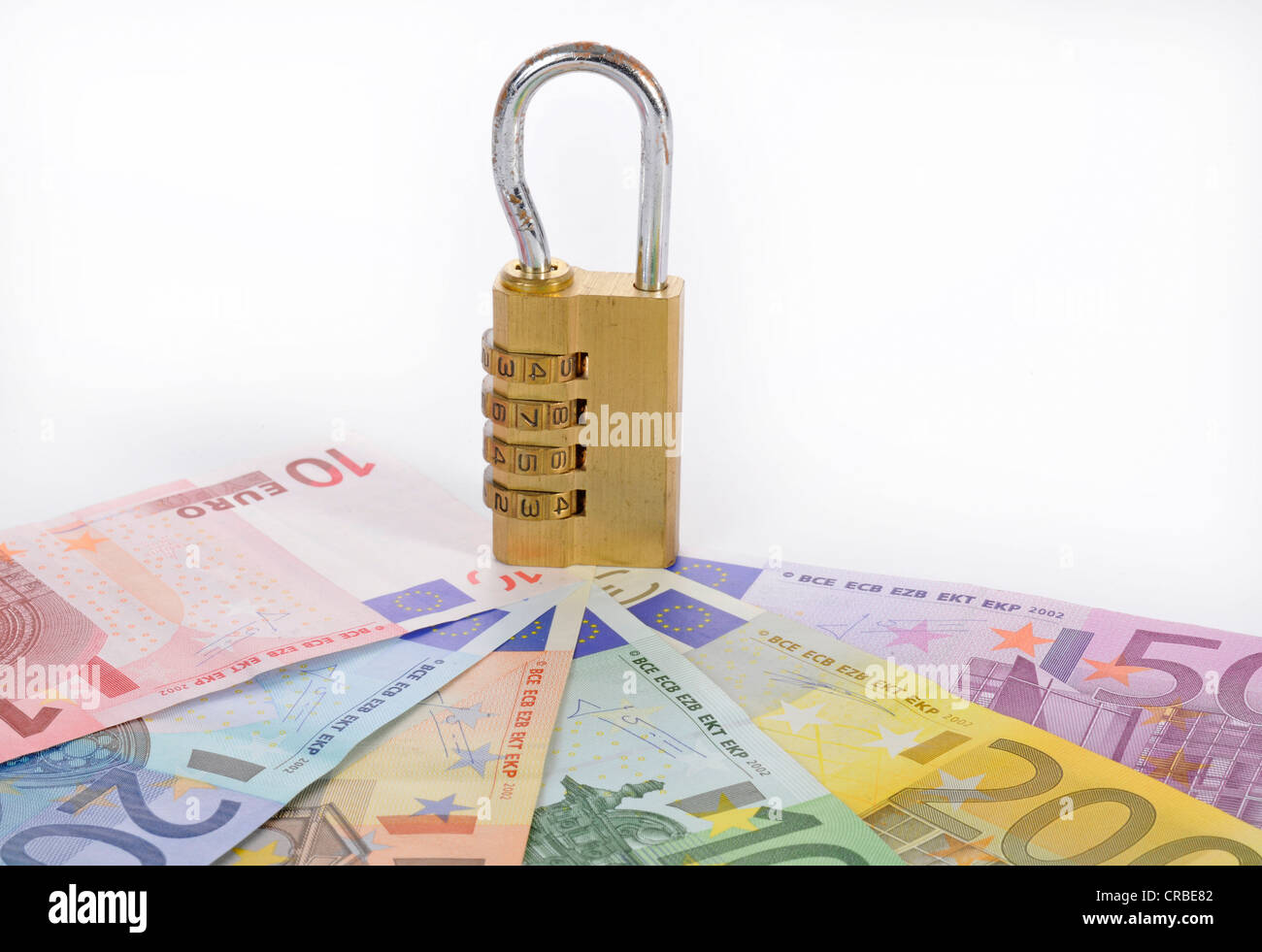 Combination lock on euro banknotes, symbolic image of monetary security ...