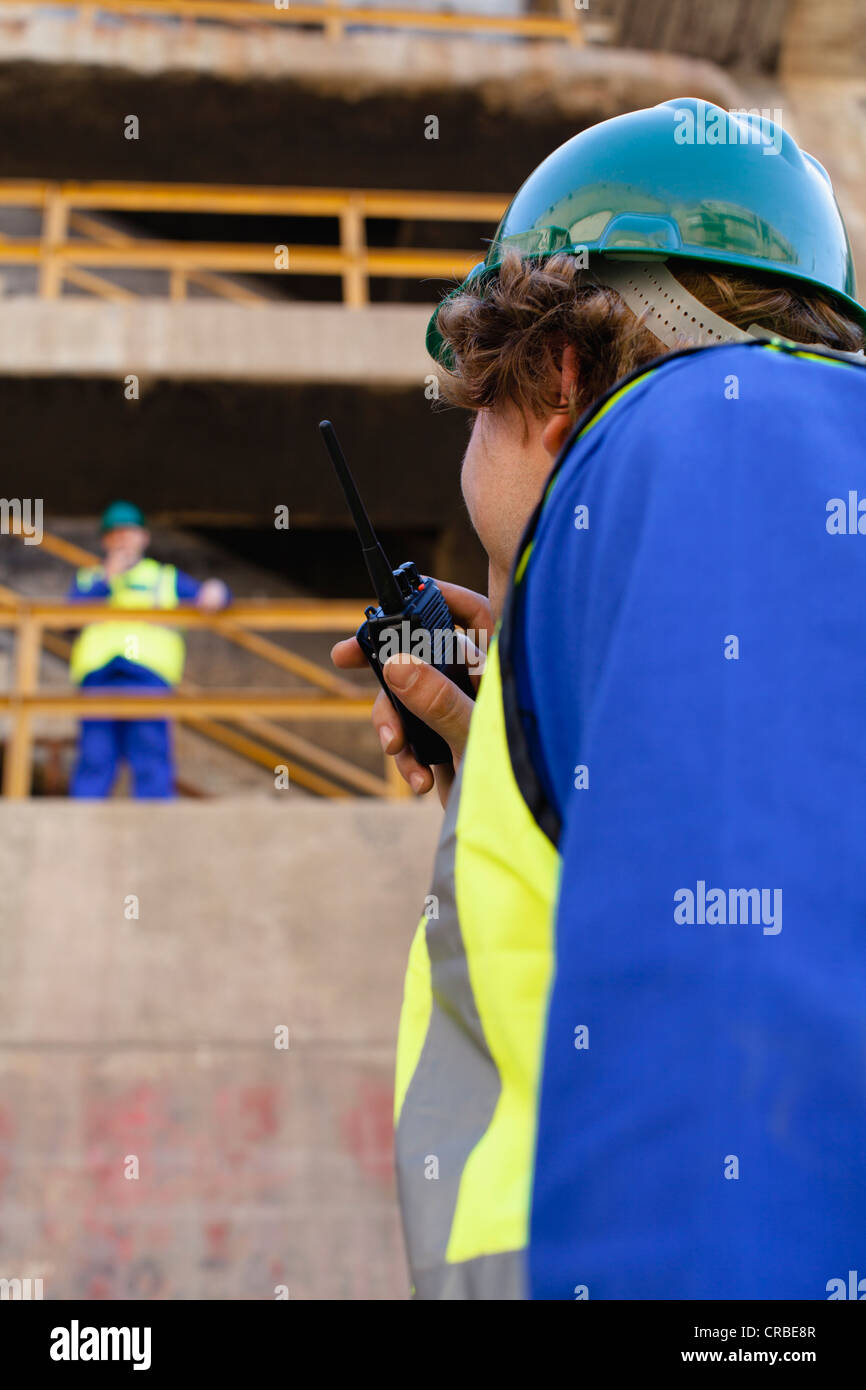 Workers using walkie talkies on dry dock Stock Photo - Alamy