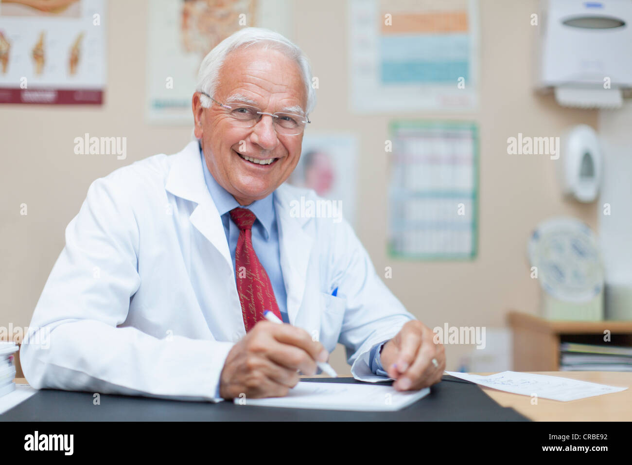 Doctor writing notes in office Stock Photo - Alamy