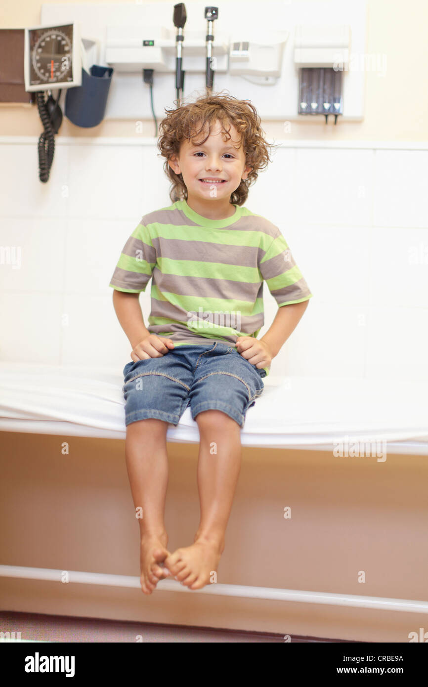Boy sitting on examination table hi-res stock photography and images ...