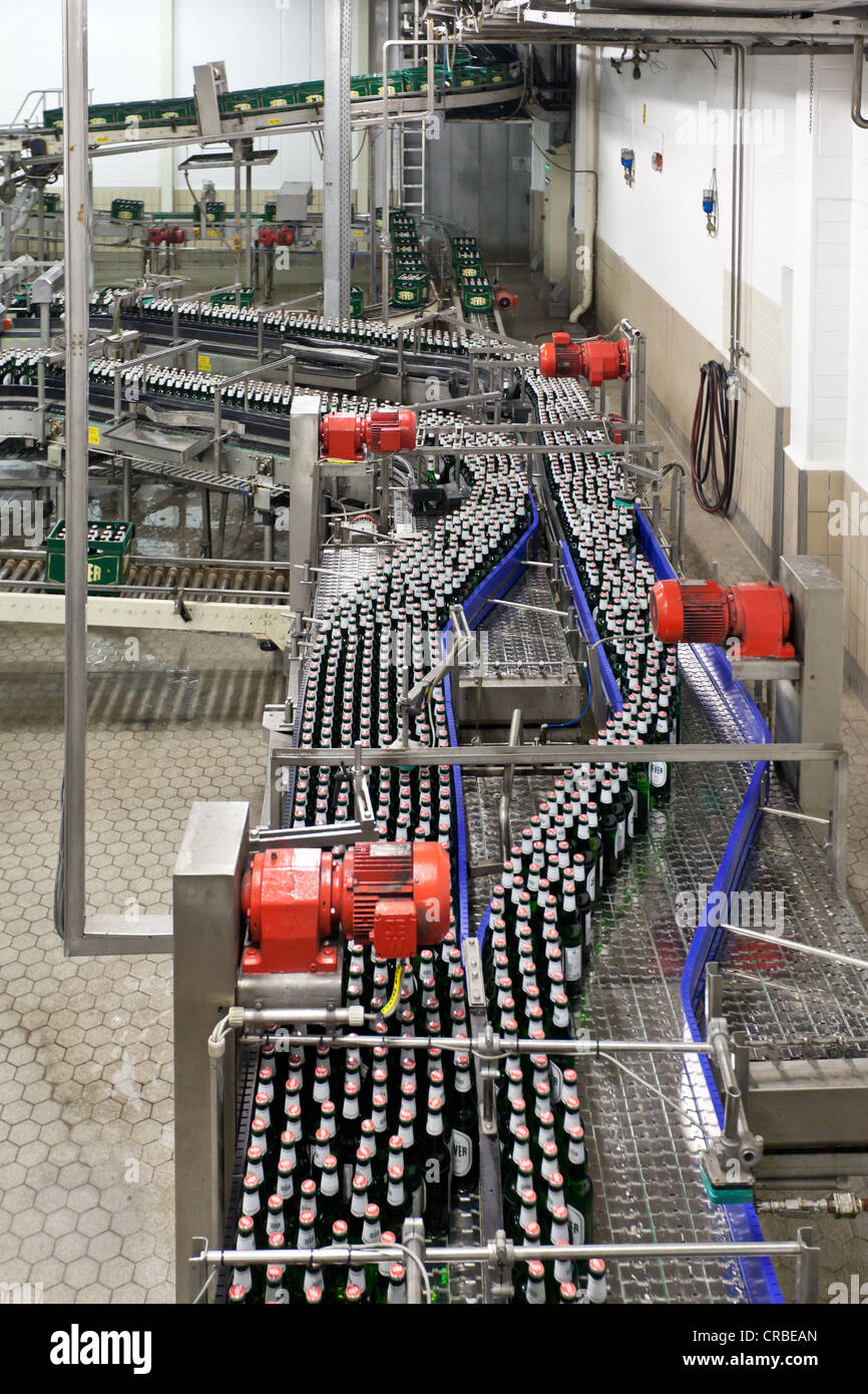 Beer bottles being filled on a conveyor belt, Binding brewery ...