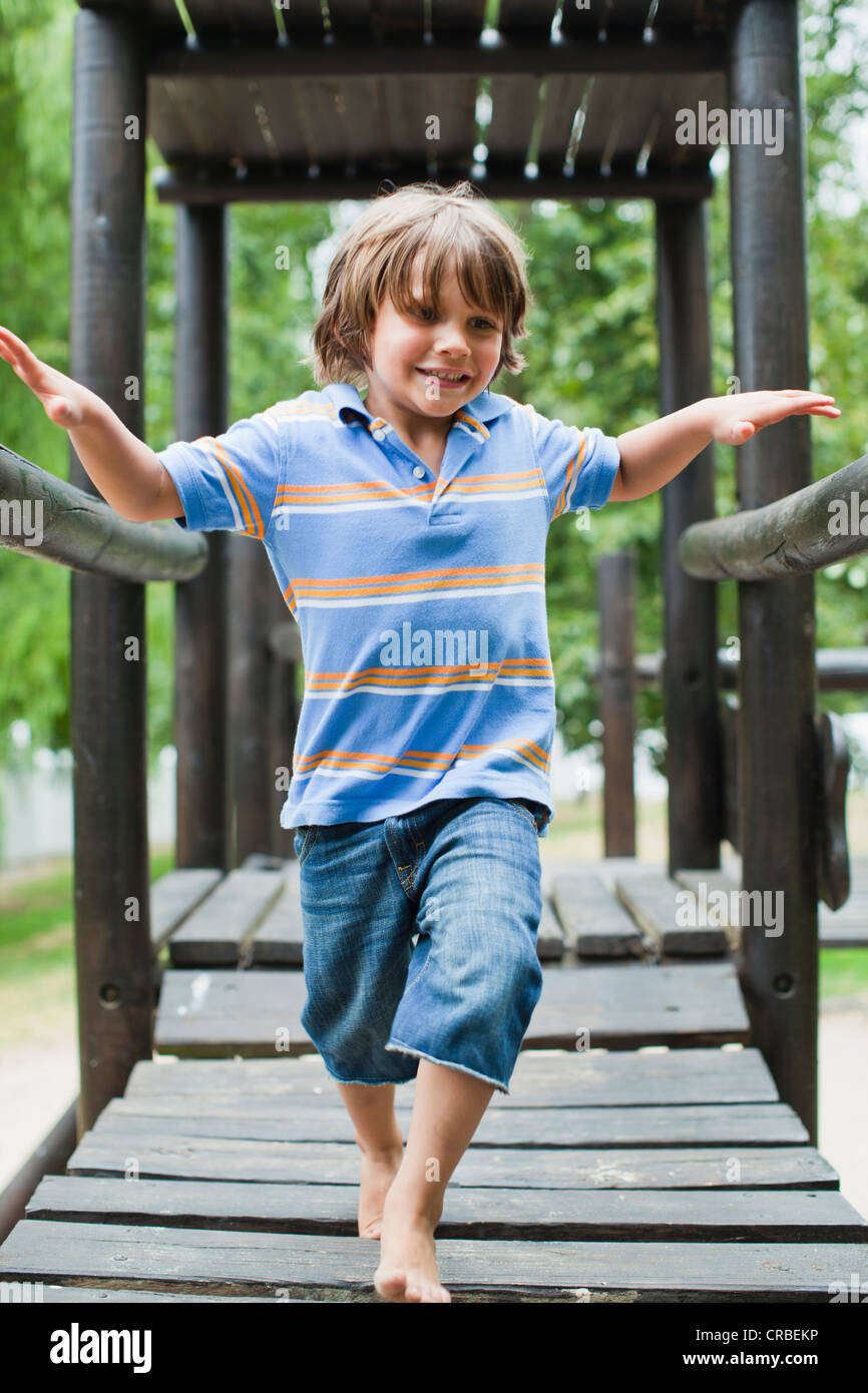 Boy playing on play structure Stock Photo - Alamy