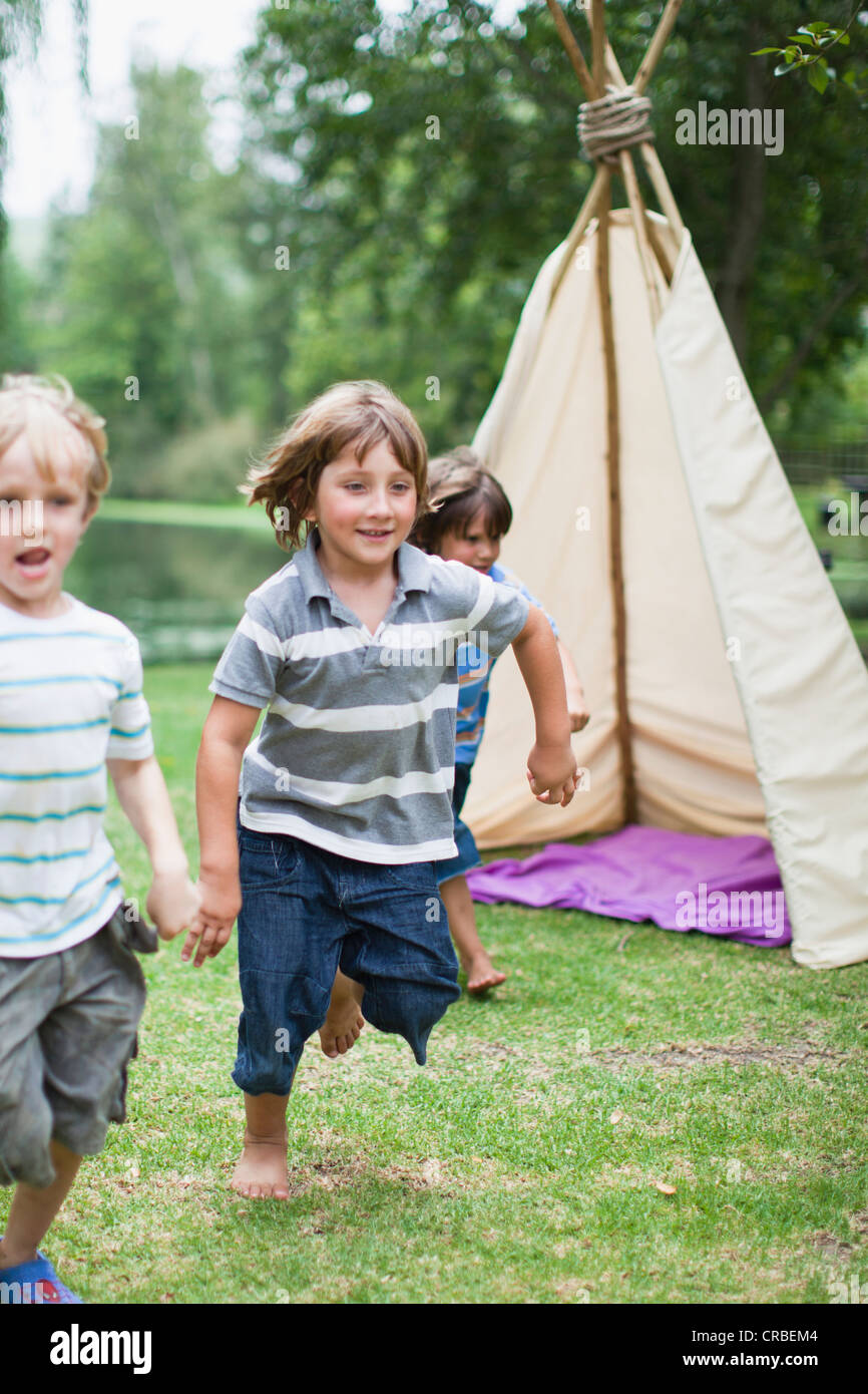 Boys playing together outdoors Stock Photo - Alamy