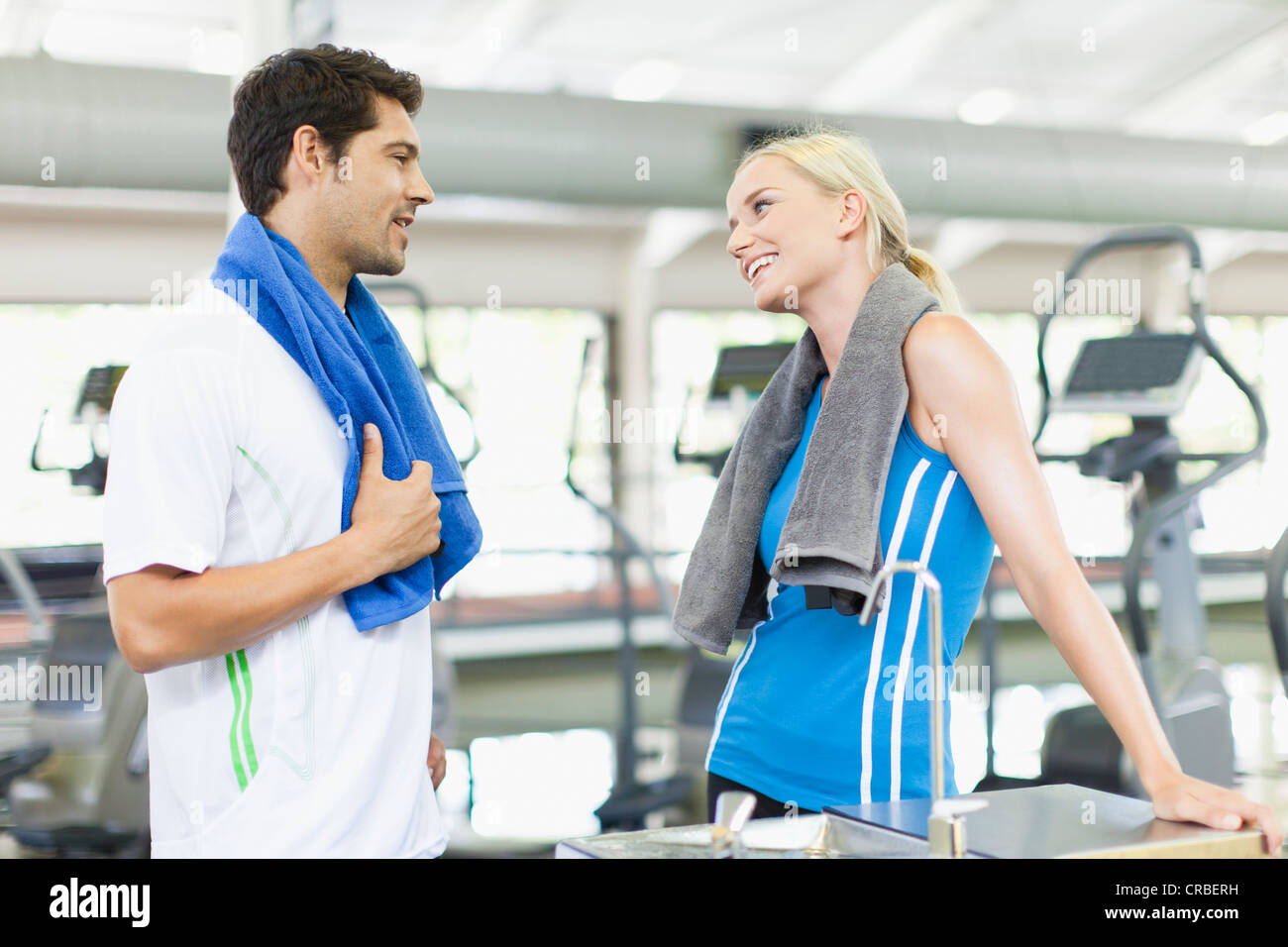Couple talking in gym Stock Photo - Alamy