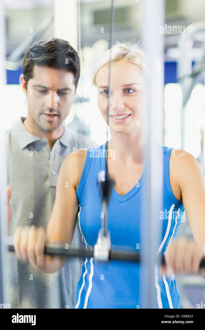 Woman working with trainer in gym Stock Photo - Alamy