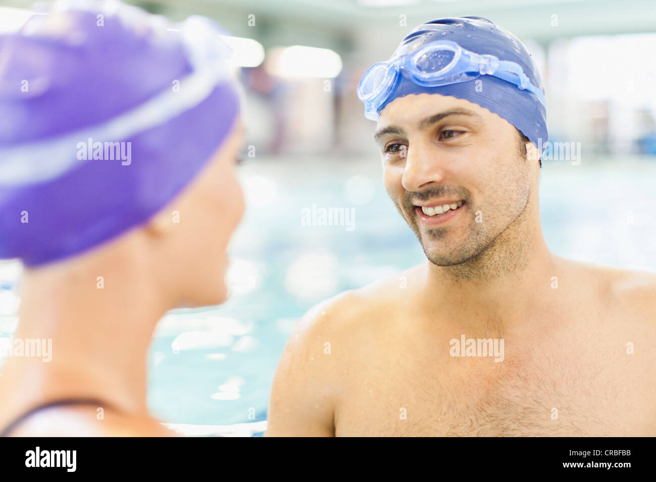 Swimmers talking by pool Stock Photo - Alamy