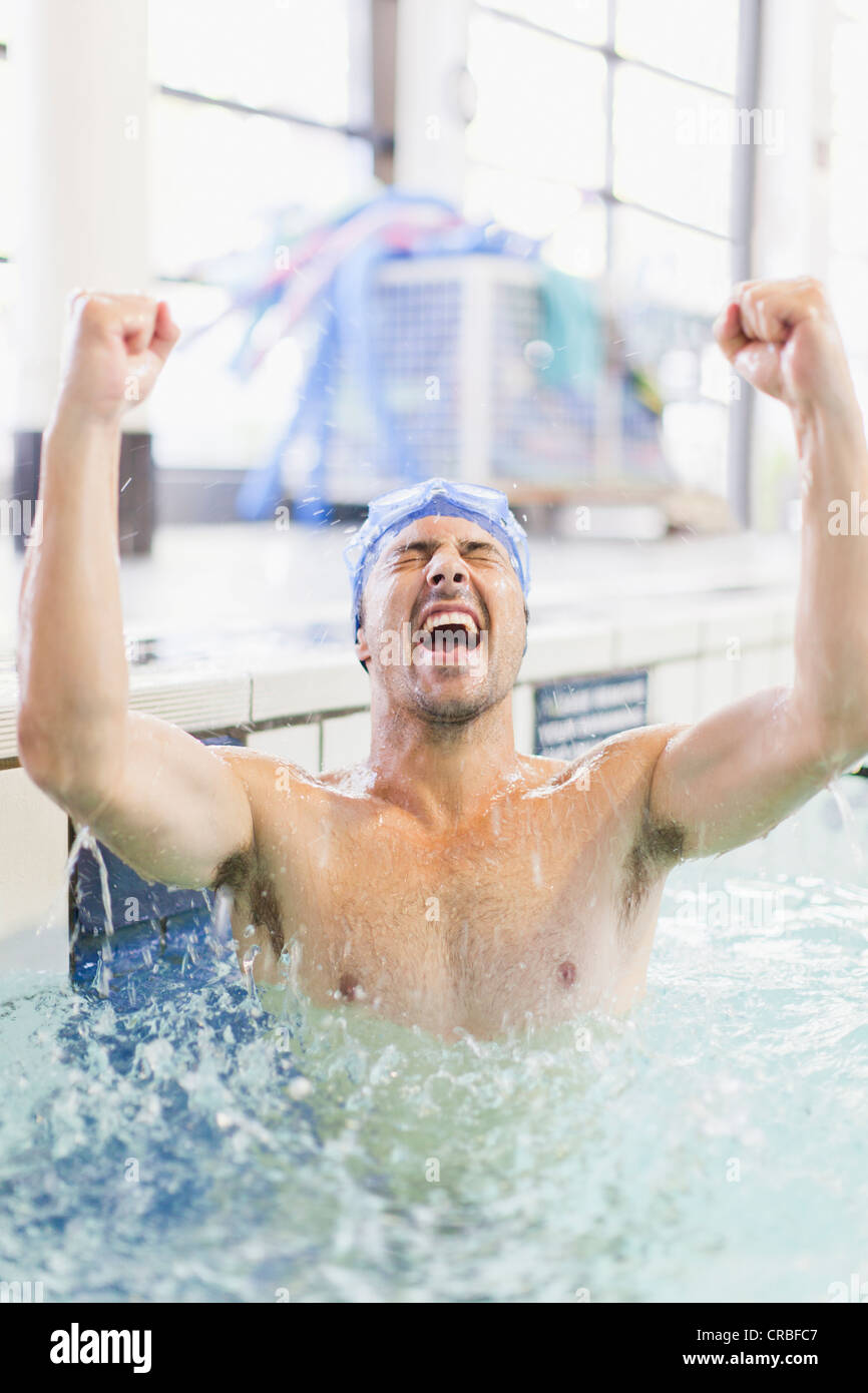 Swimmer cheering in pool Stock Photo - Alamy