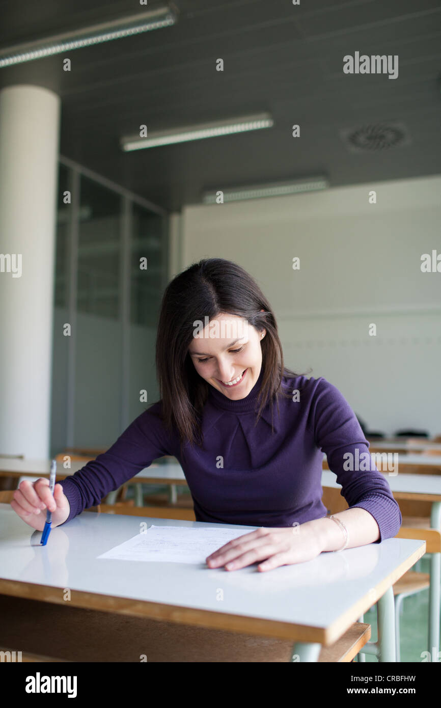 portrait of a pretty college student working in a classroom Stock Photo ...