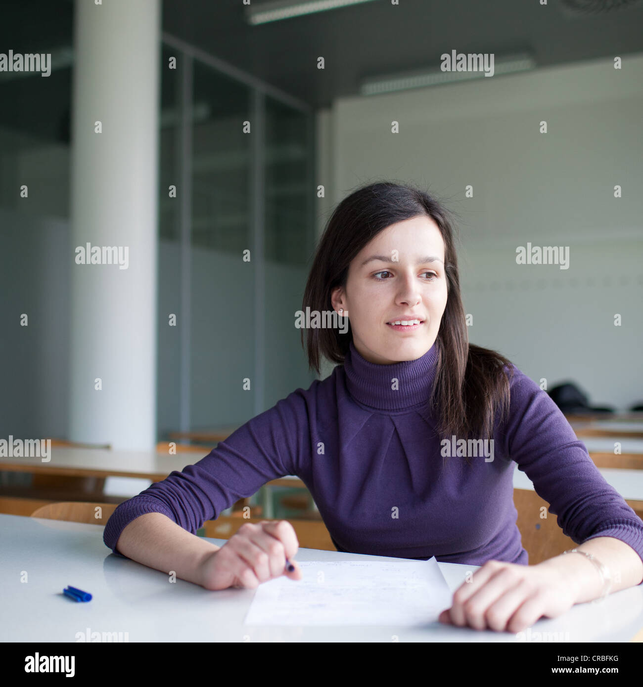 portrait of a pretty college student working in a classroom Stock Photo ...