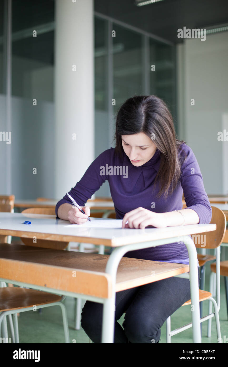 portrait of a pretty college student working in a classroom Stock Photo ...