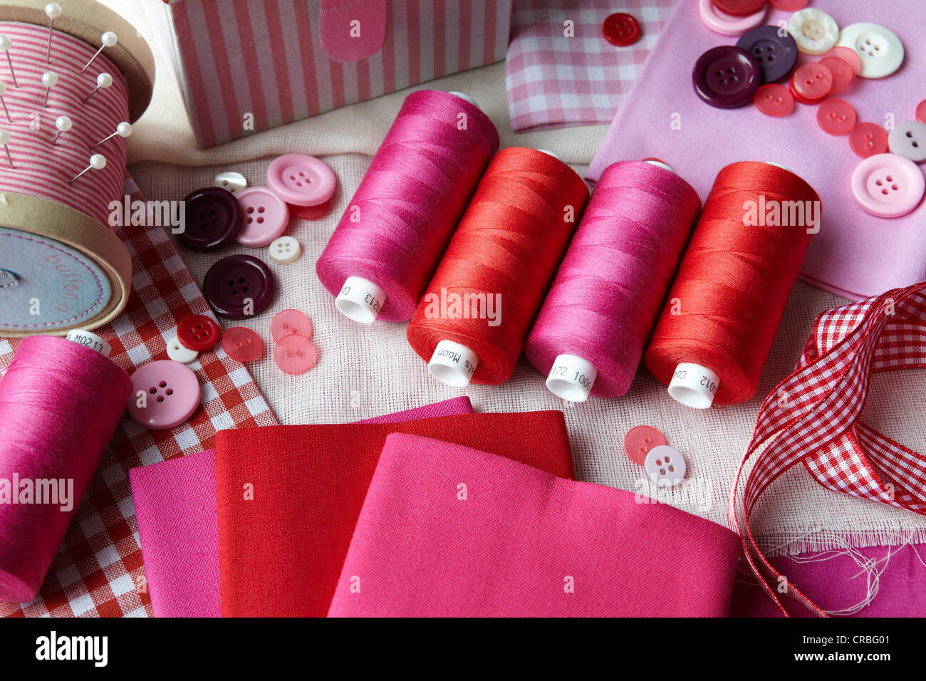 Thread, buttons, measuring tape on desk Stock Photo - Alamy