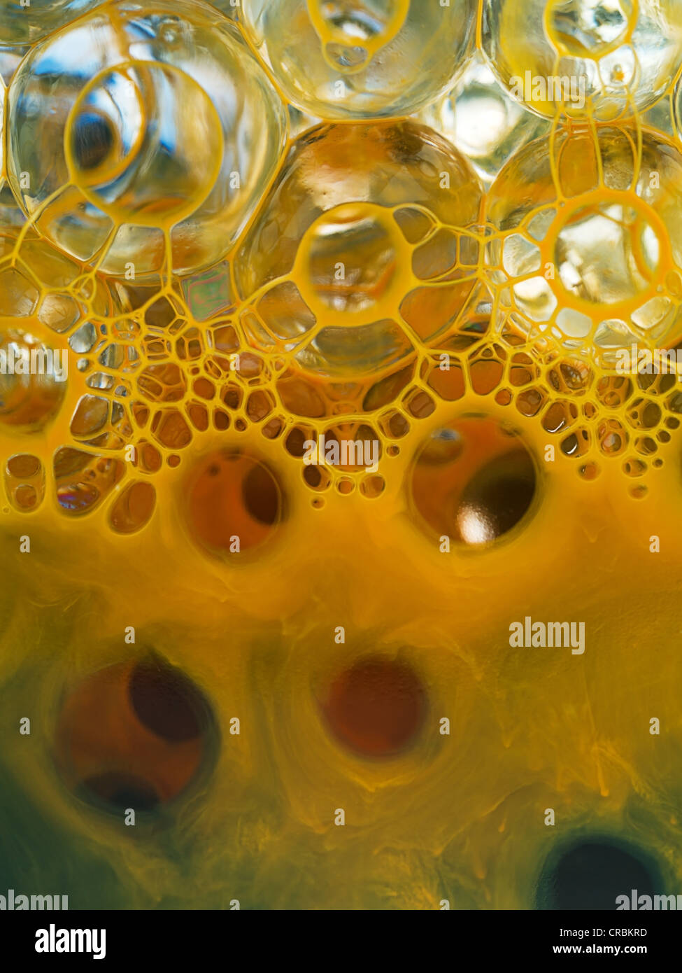 ball transparent liquid with yellow pigment and green Stock Photo - Alamy