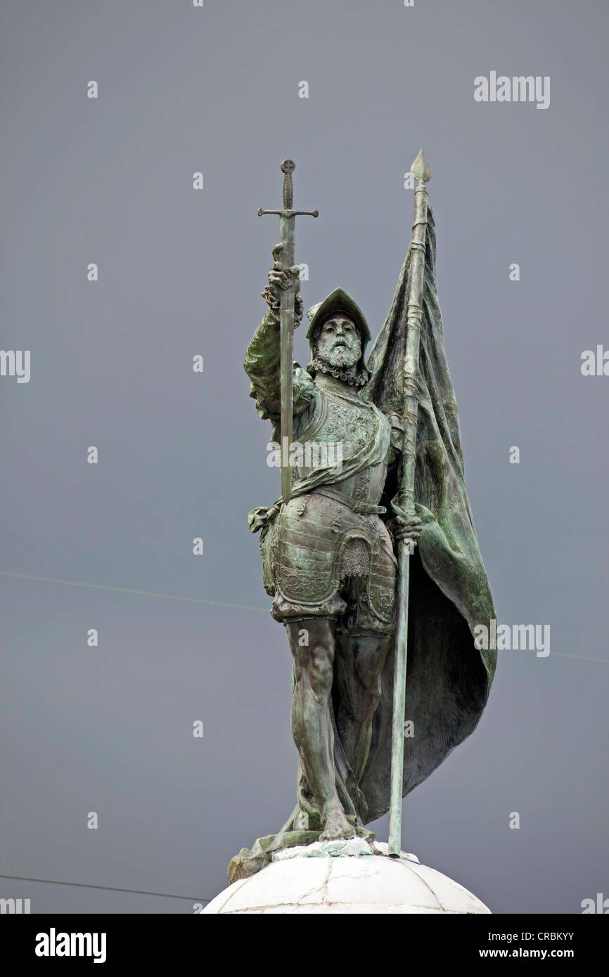 Bronze statue of the explorer Vasco Núñez Balboa standing on a globe ...