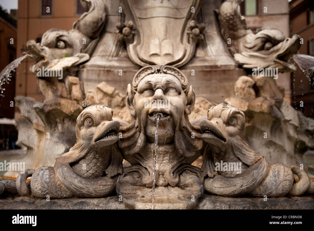 Head spouting water, detail of the fountain with the obelisk on the ...