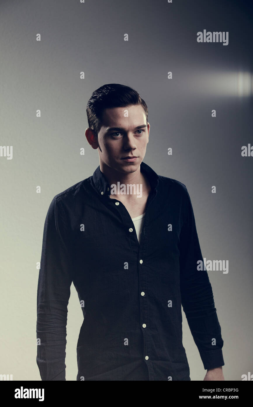 Man wearing button-up shirt indoors Stock Photo - Alamy