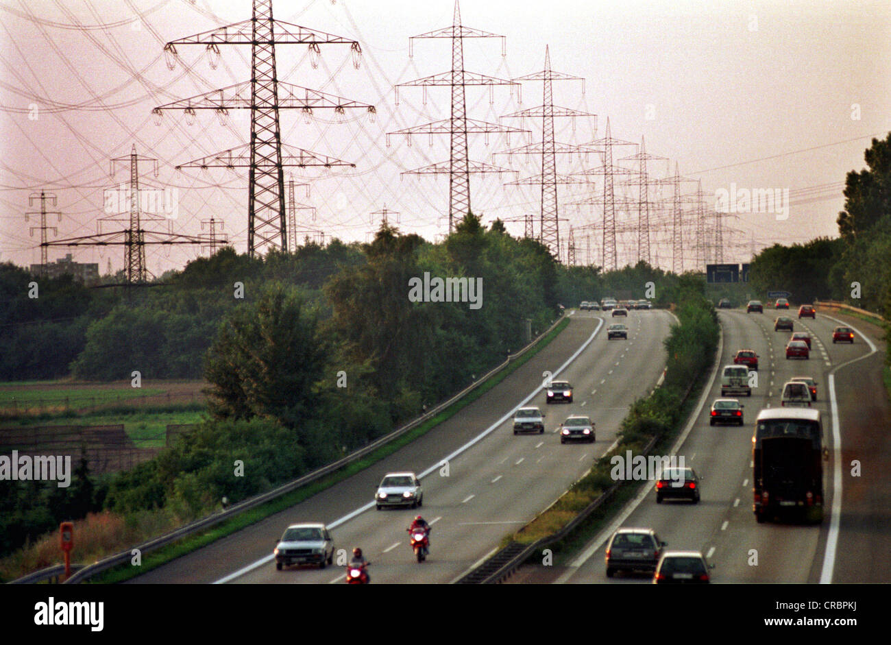 Electricity pylons along a highway Stock Photo - Alamy