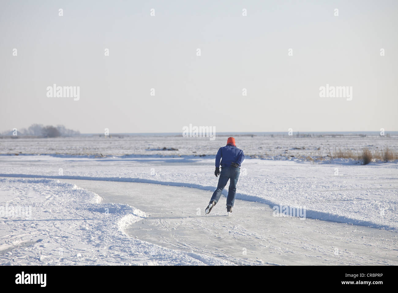 Man skating on frozen river Stock Photo - Alamy