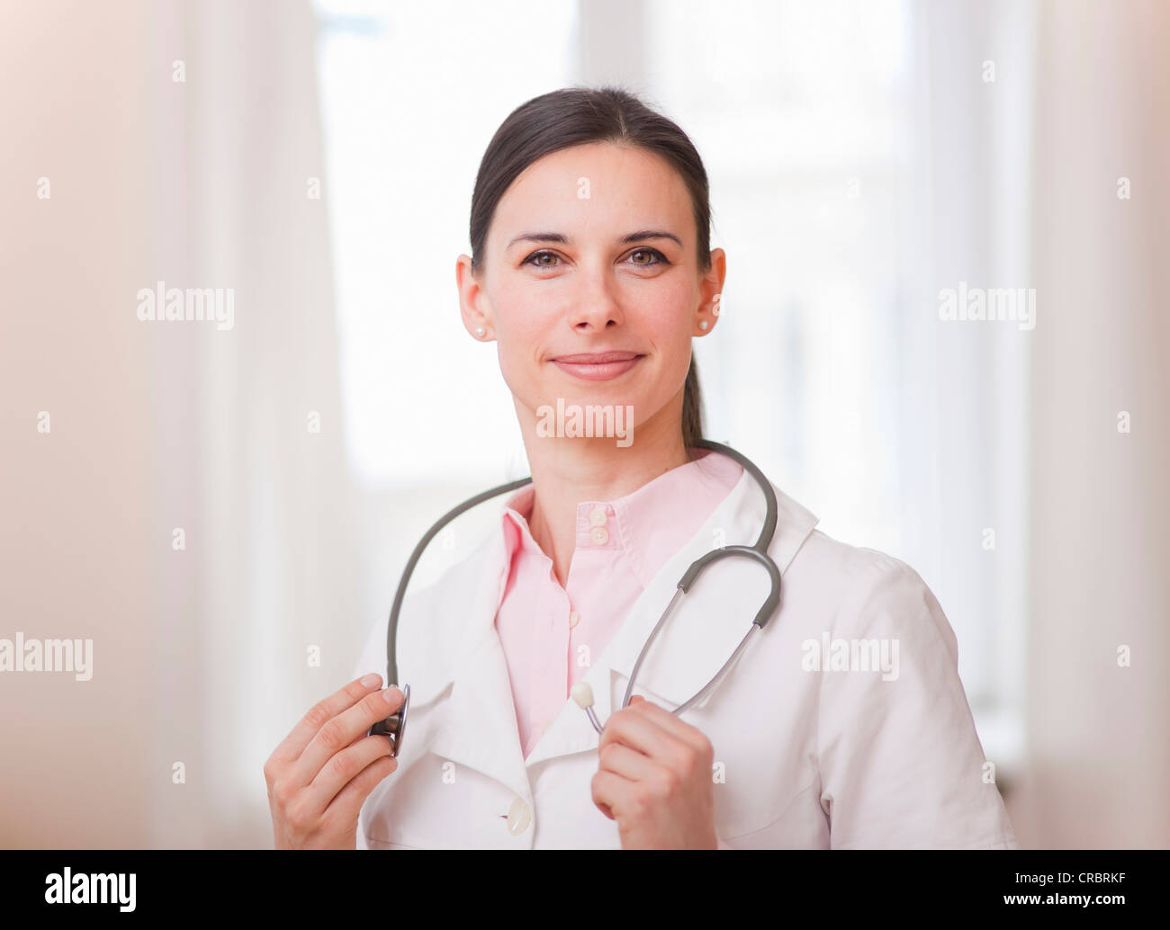 Smiling doctor wearing stethoscope Stock Photo - Alamy