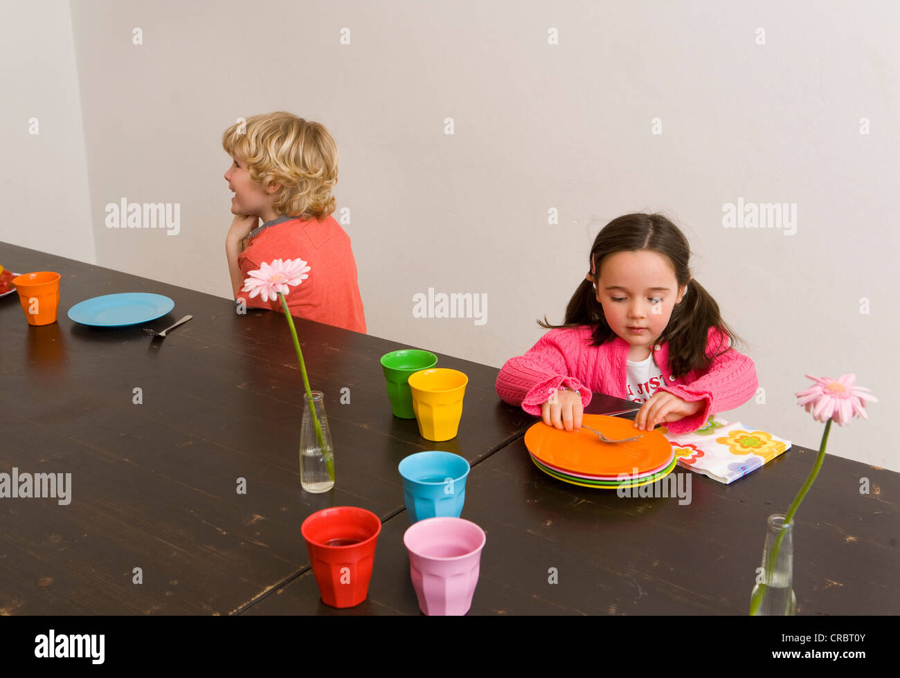 Children playing at table in kitchen Stock Photo - Alamy