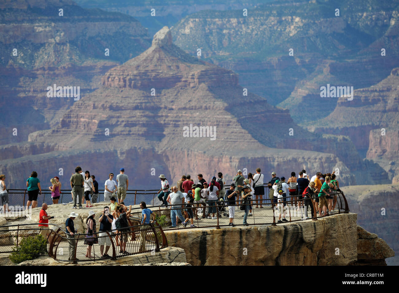Tourists on Mather Point lookout, overlooking Isis Temple, Grand Canyon ...