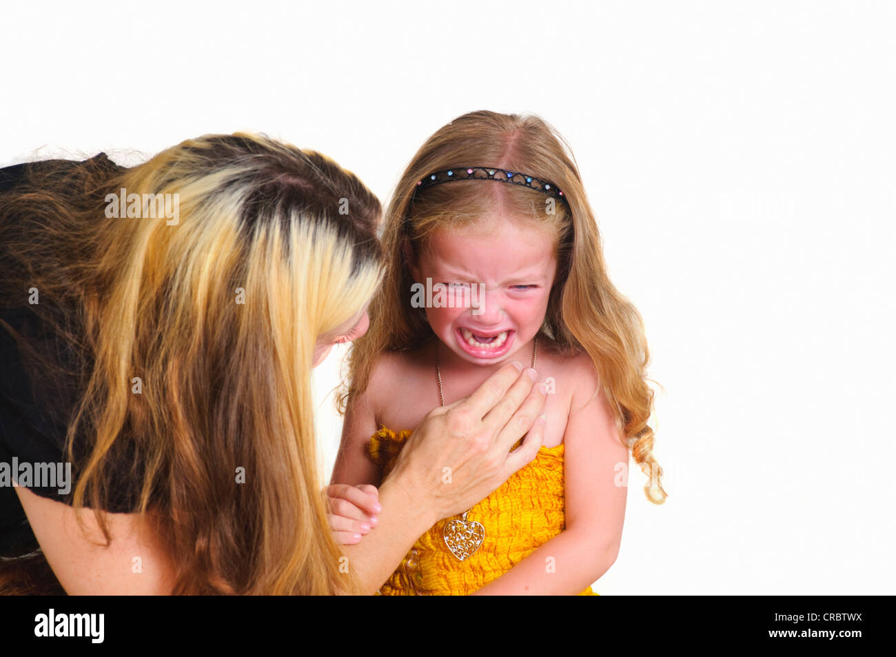 Mother comforting crying girl Stock Photo - Alamy