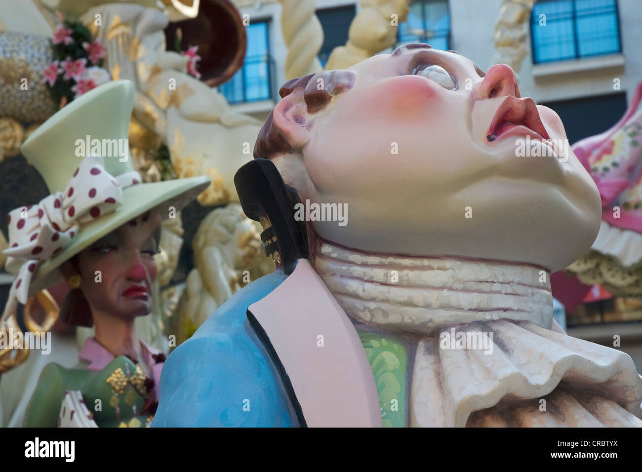 Crude carnival characters and satirical sculptures at a parade, Fallas ...