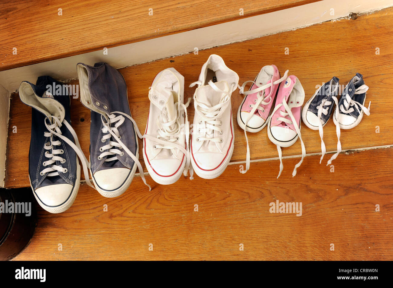 Sport shoes of a family with two children, lined up on a stair Stock ...