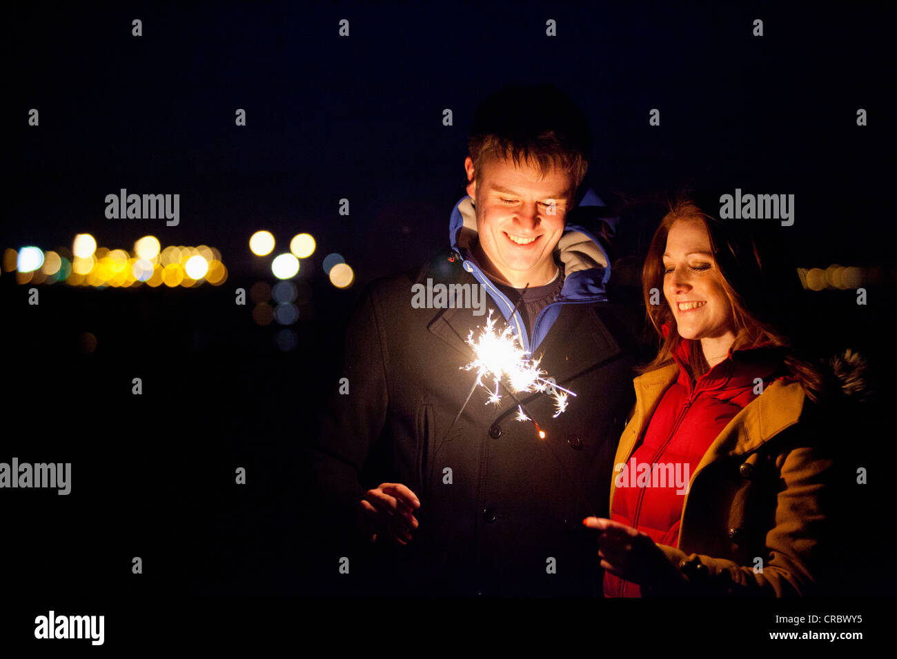 Two young women playing sparklers hi-res stock photography and images ...