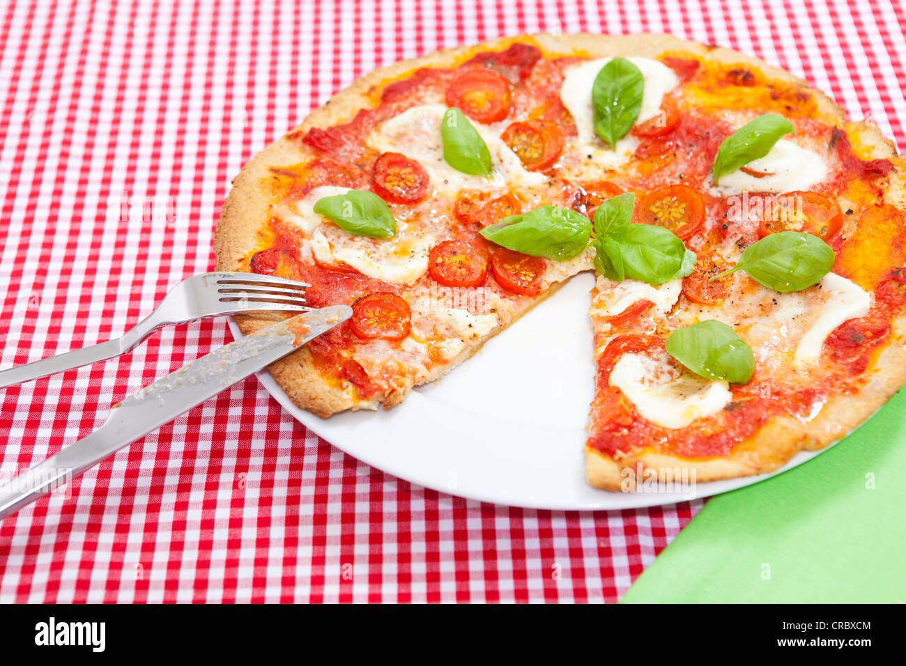 Pizza on checkered tablecloth Stock Photo - Alamy
