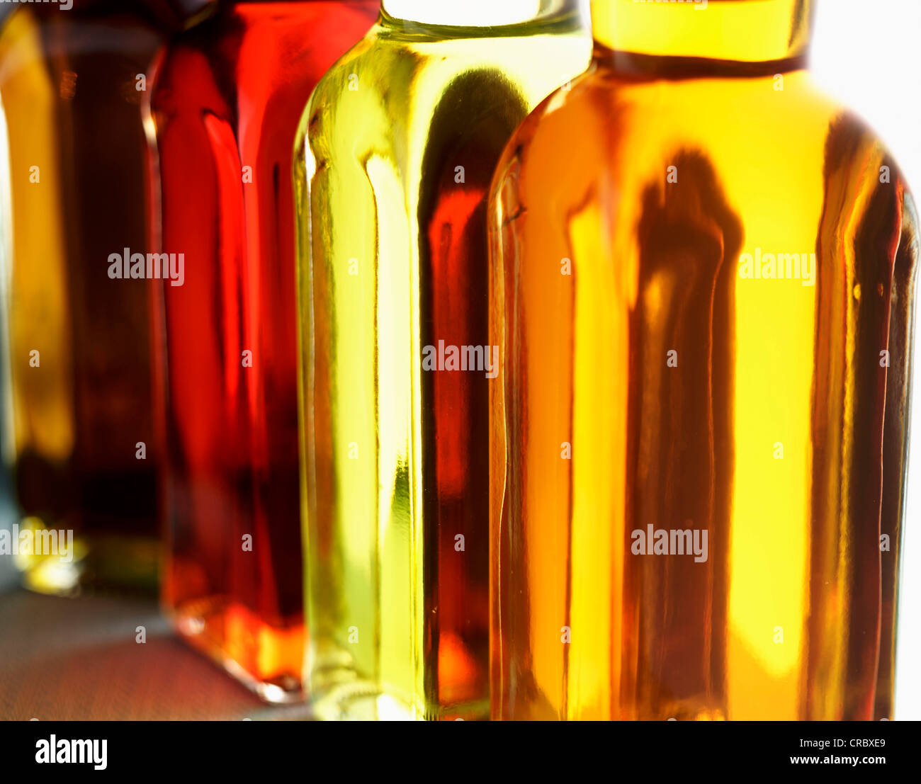 a selection of colored cooking oils in a row Stock Photo - Alamy