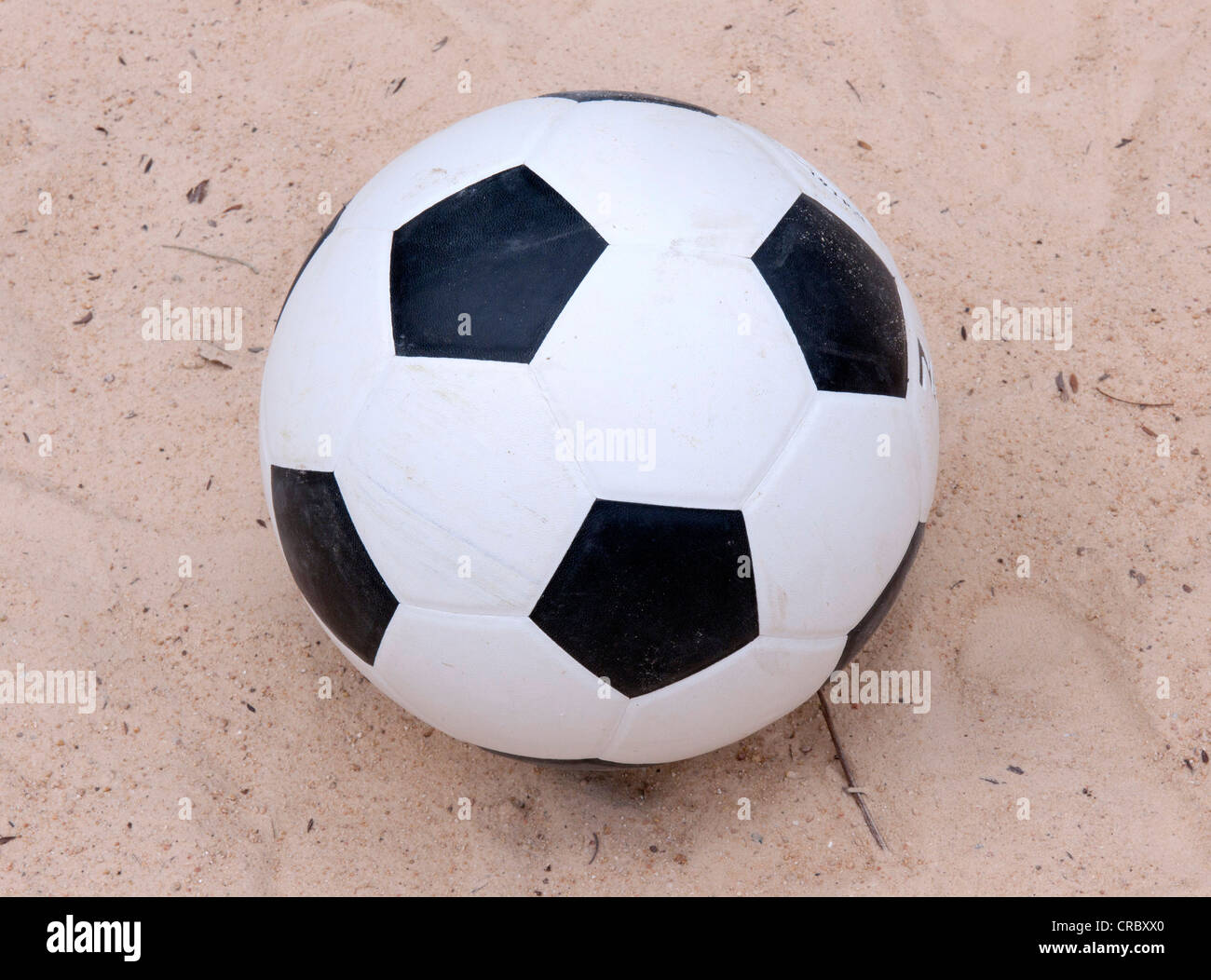 Football lying on sand Stock Photo - Alamy