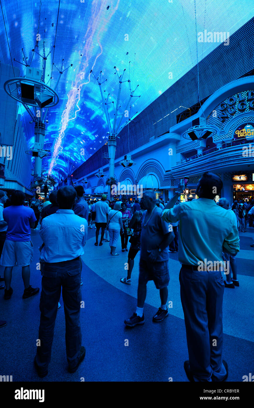 Tourists marveling at the neon dome of the Fremont Street Experience in ...