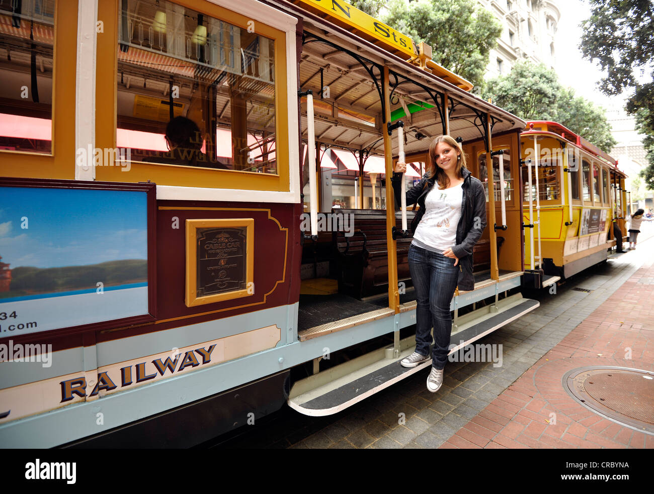 Young woman posing on a cable car, cable tramway, Powell and Hyde ...