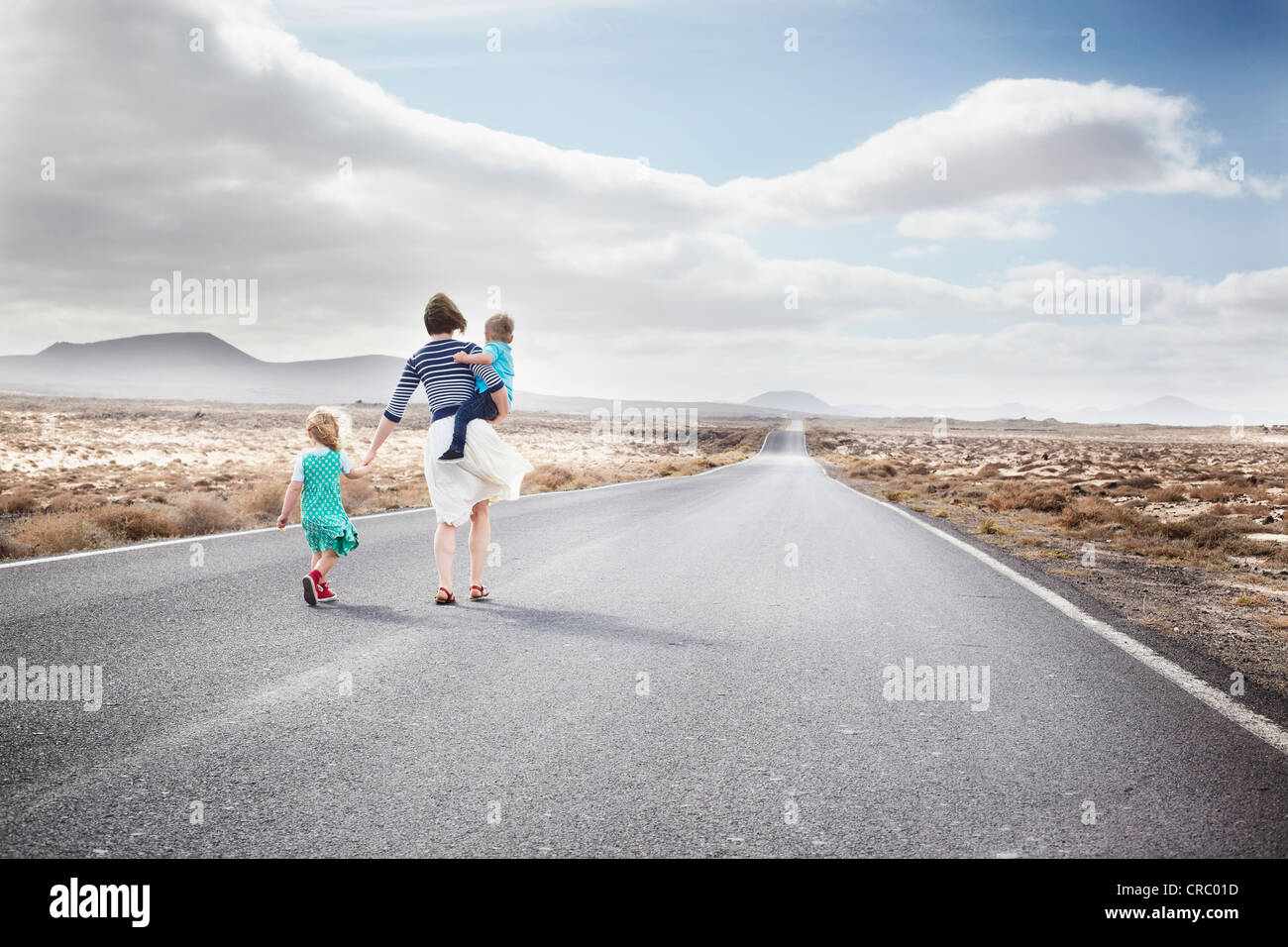 Family walking on paved rural road Stock Photo - Alamy