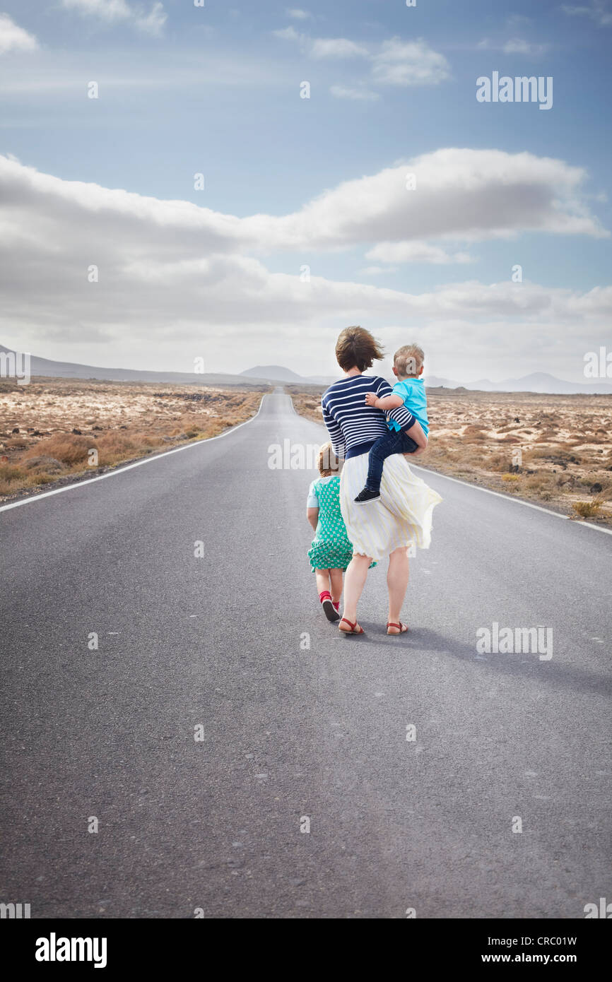 Family walking on paved rural road Stock Photo - Alamy