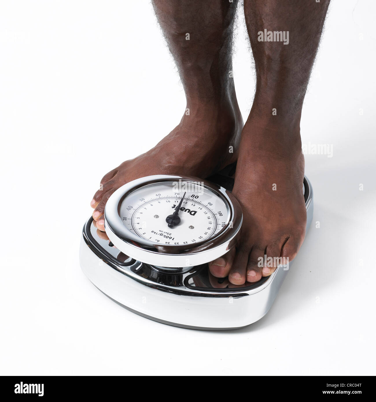 man standing on weighing scales Stock Photo - Alamy