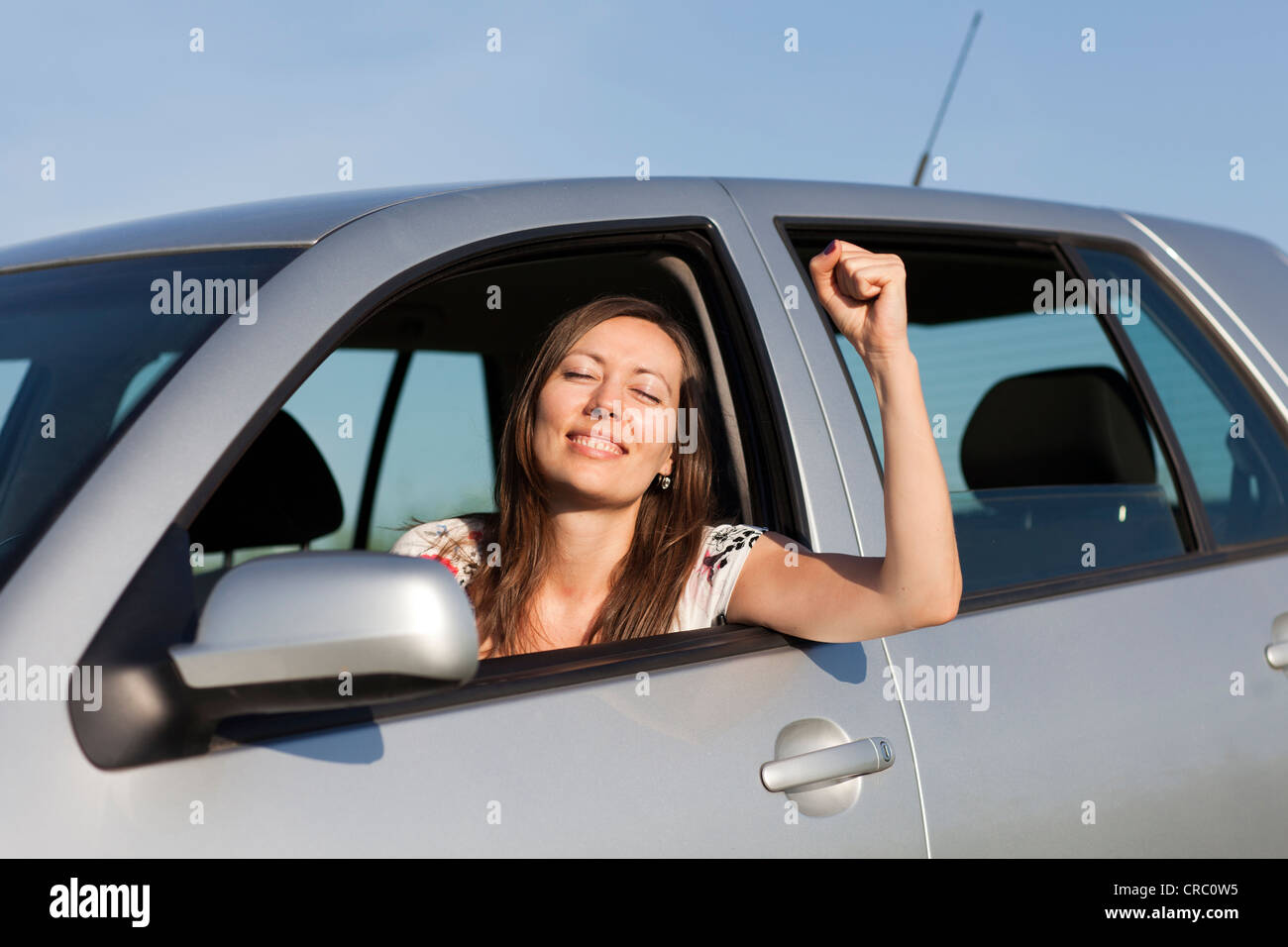 Woman happy in car Stock Photo - Alamy