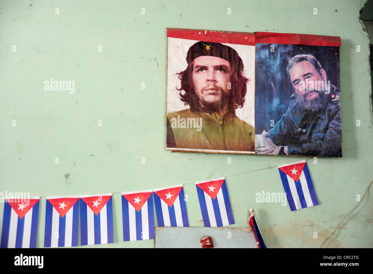 Green wall with national flags made of paper, photos of Che Guevara and ...