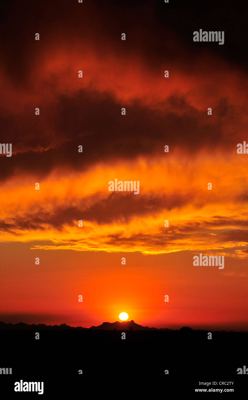 A sunset colors the sky on the first day of monsoon season in the ...