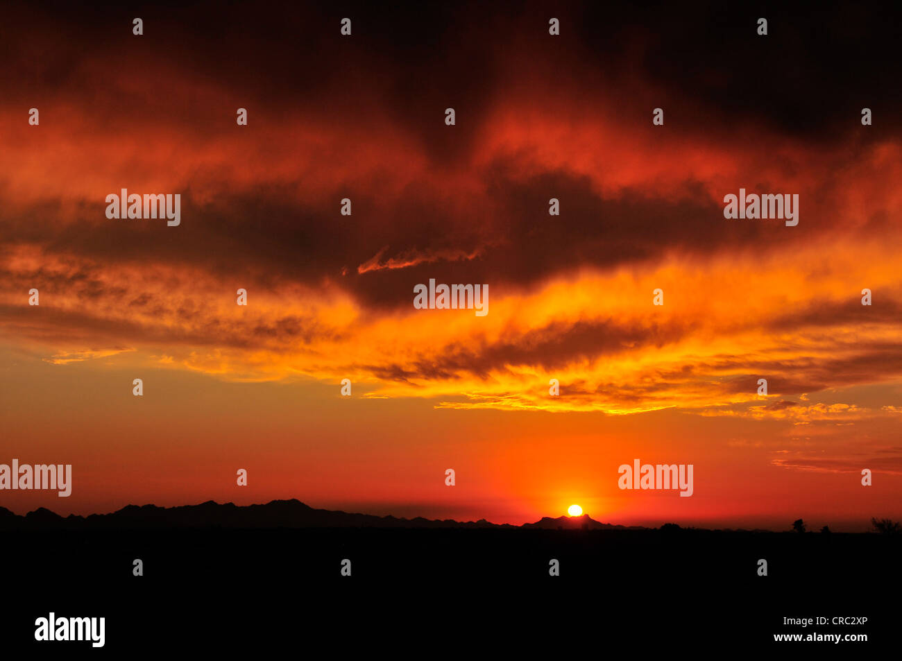 A sunset colors the sky on the first day of monsoon season in the ...