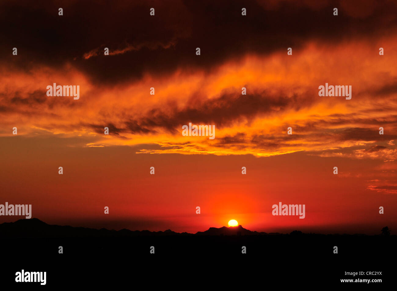 A sunset colors the sky on the first day of monsoon season in the ...