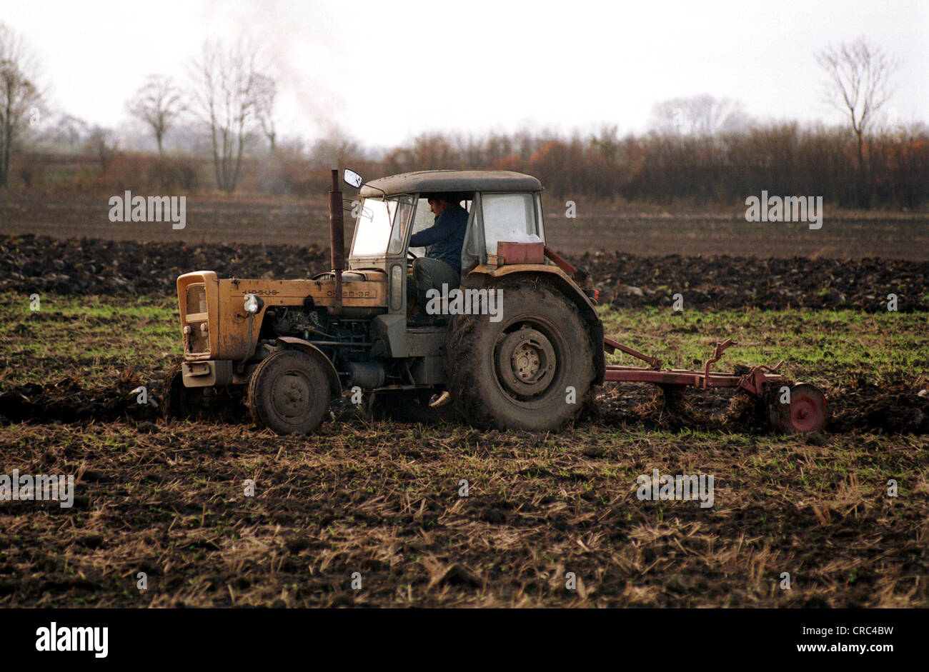 Farmer plowing his field with a tractor, Brzeg, Poland Stock Photo - Alamy