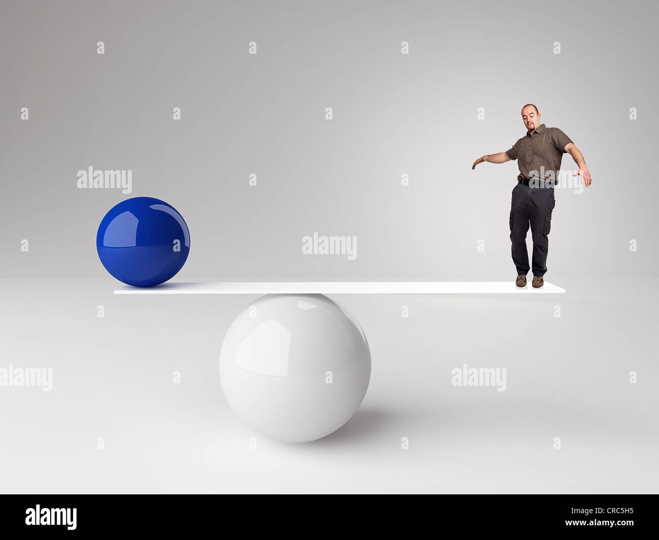 3d image of ball and man in false balance Stock Photo - Alamy