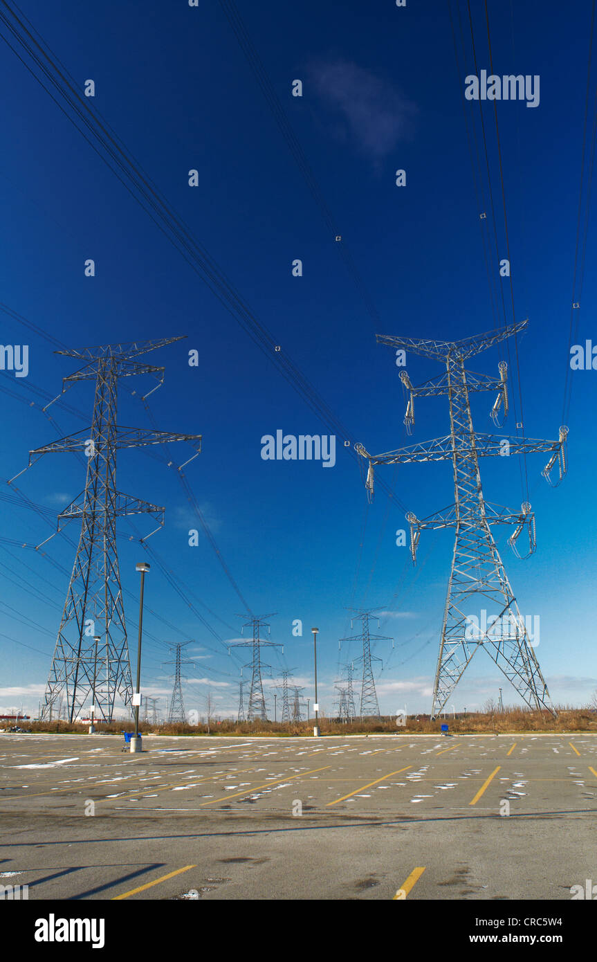 Power lines against blue sky Stock Photo - Alamy