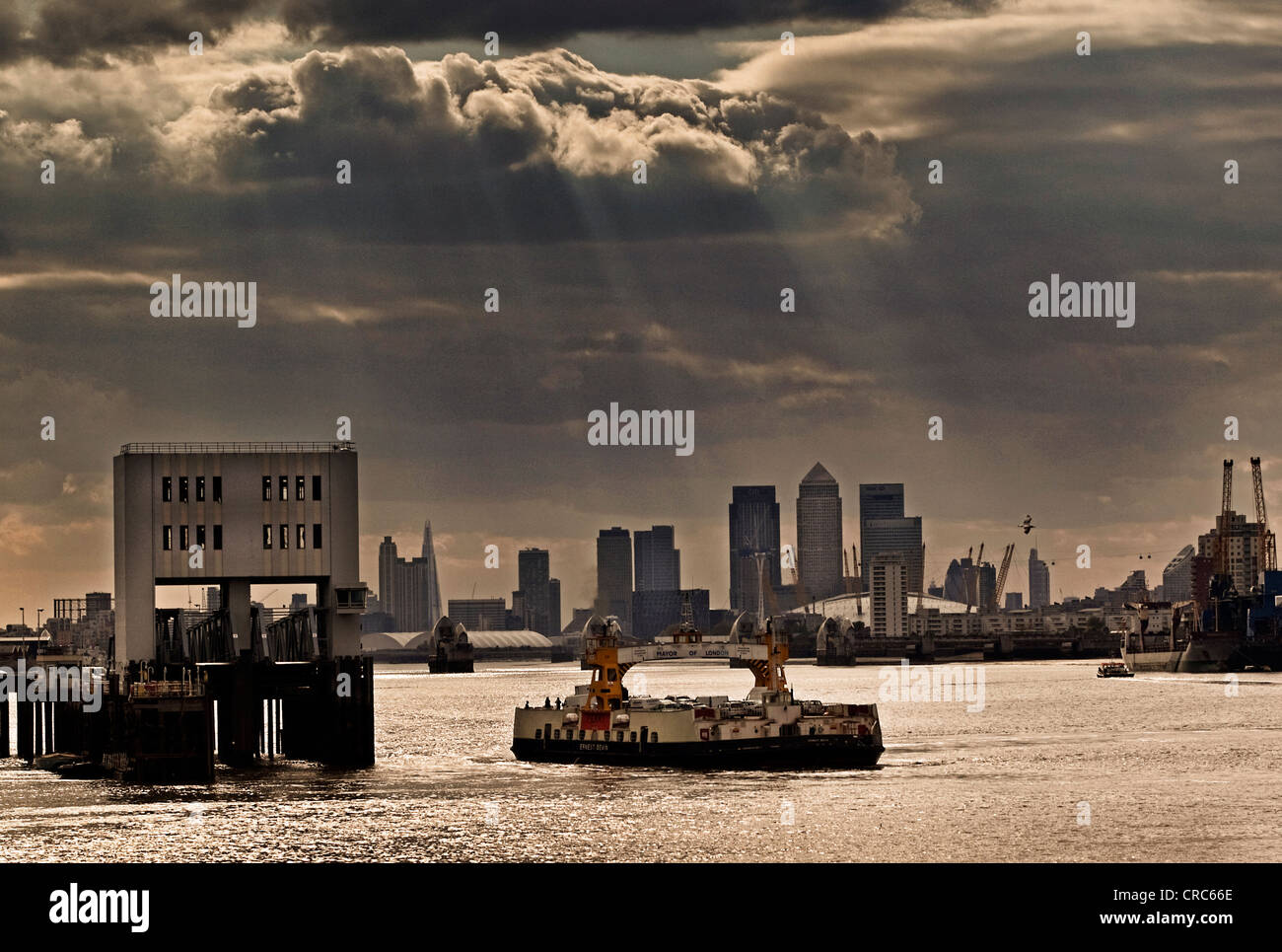 Woolwich Ferry on the River Thames London with Canary Wharf in the ...