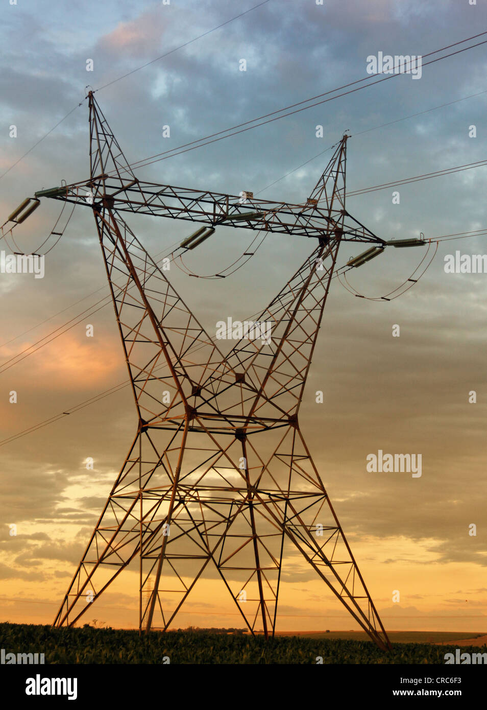Eletricity tower providing energy distribution over sunset Stock Photo ...