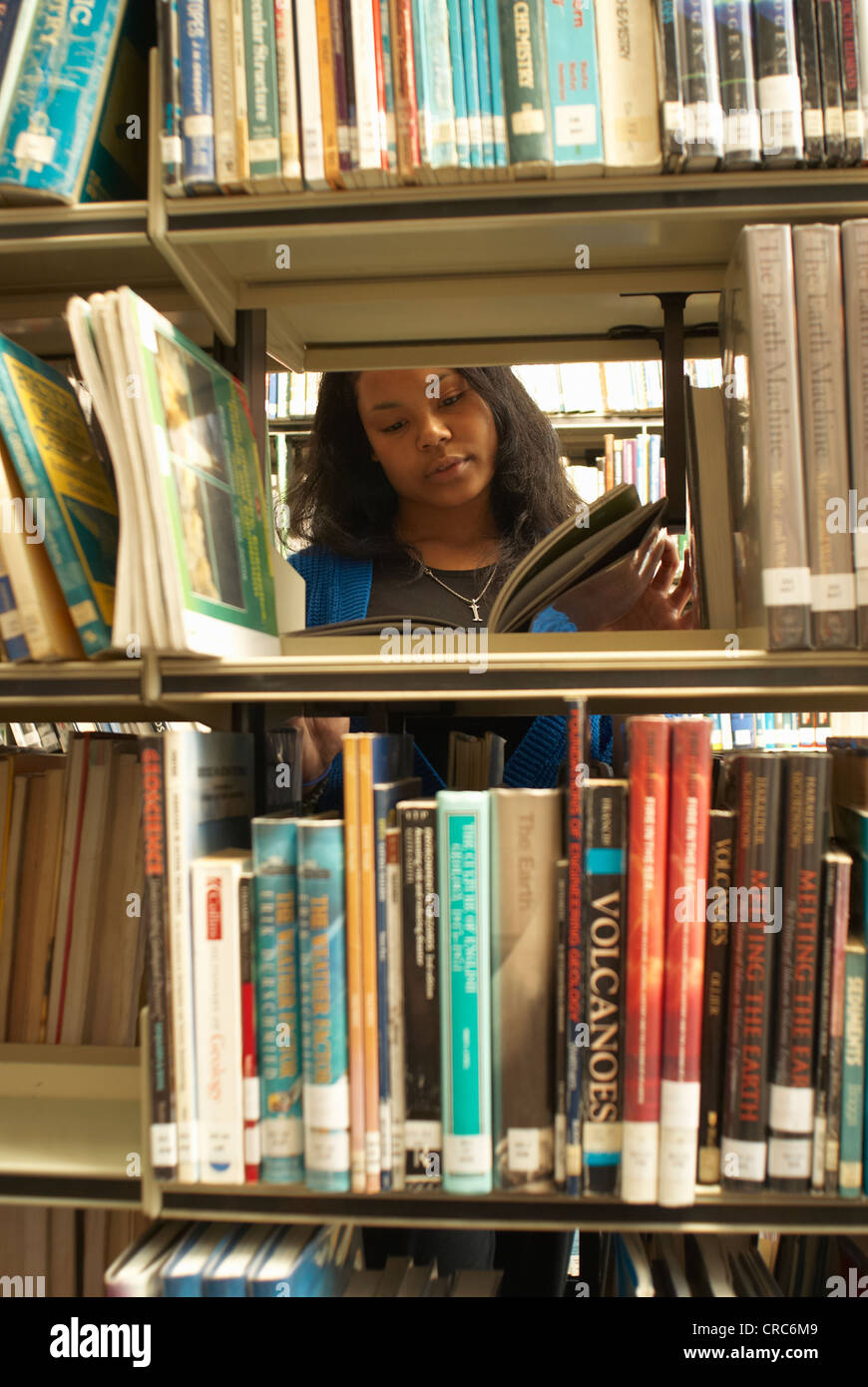 Student reading in library Stock Photo - Alamy