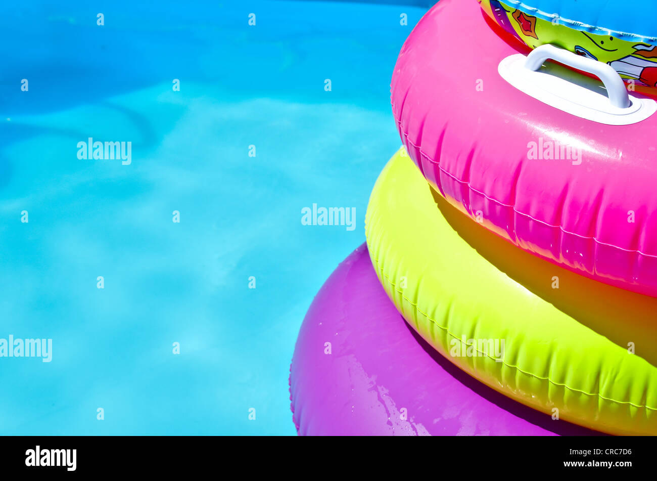 Inflateable colorfull tubes in swimming pool Stock Photo - Alamy