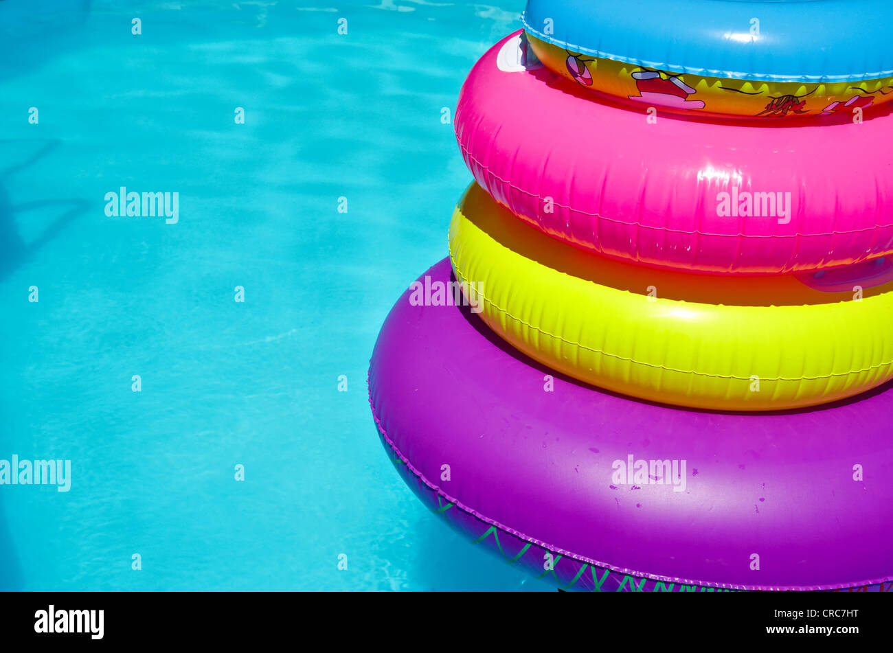 Inflateable colorfull tubes in swimming pool Stock Photo - Alamy